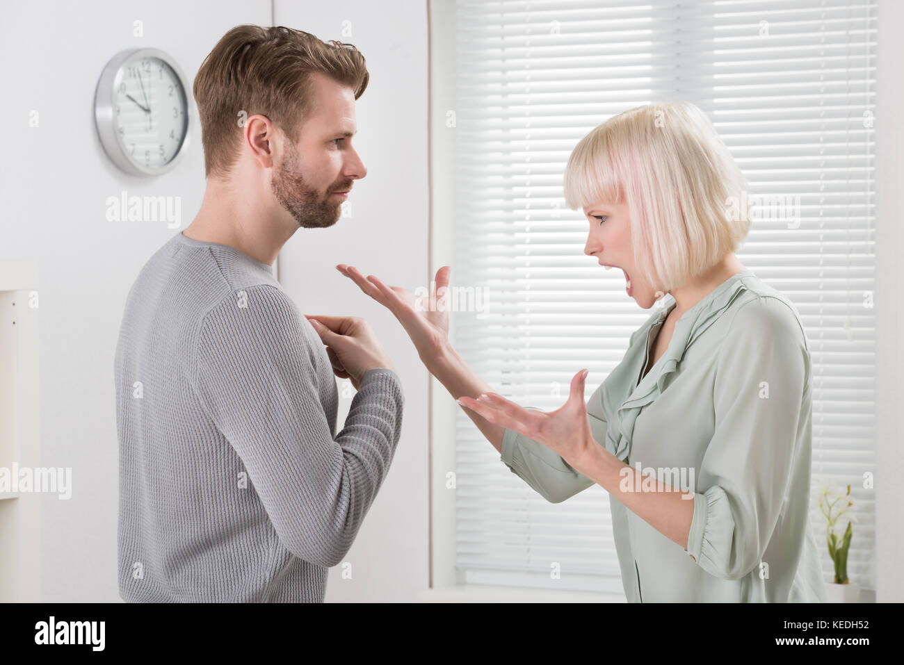 Unhappy Young Couple Arguing With Each Other At Home Stock Photo - Alamy
