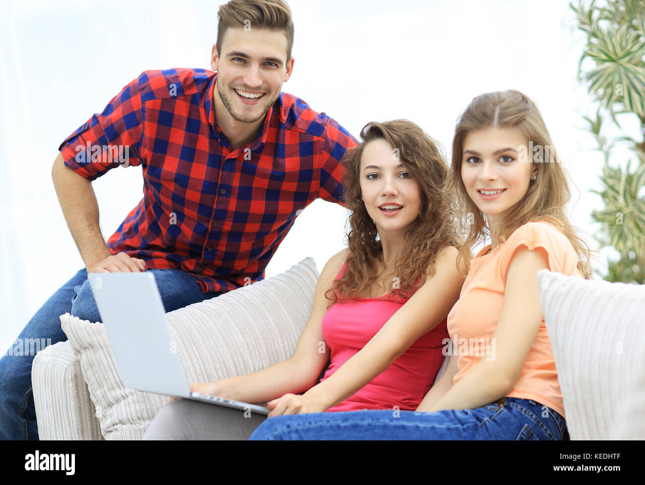 group of young people sitting on the couch in the living room Stock ...