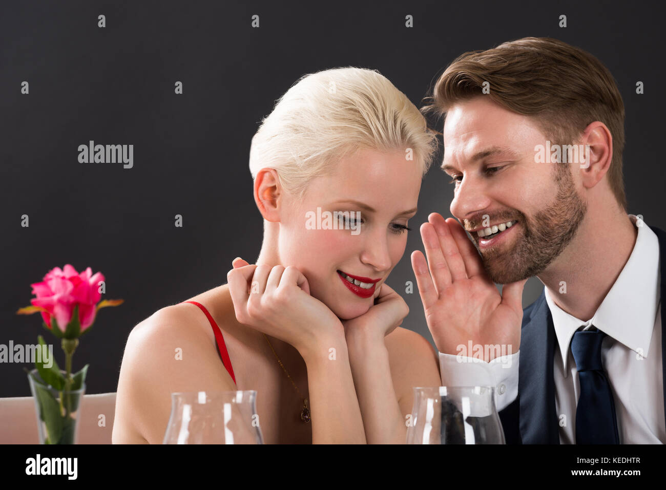 Man whispering in womans ear hi-res stock photography and images - Alamy
