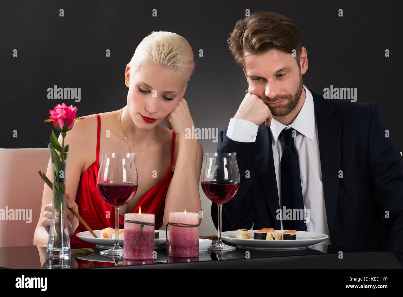Portrait Of A Sad Couple Having Dinner At A Restaurant With Black ...