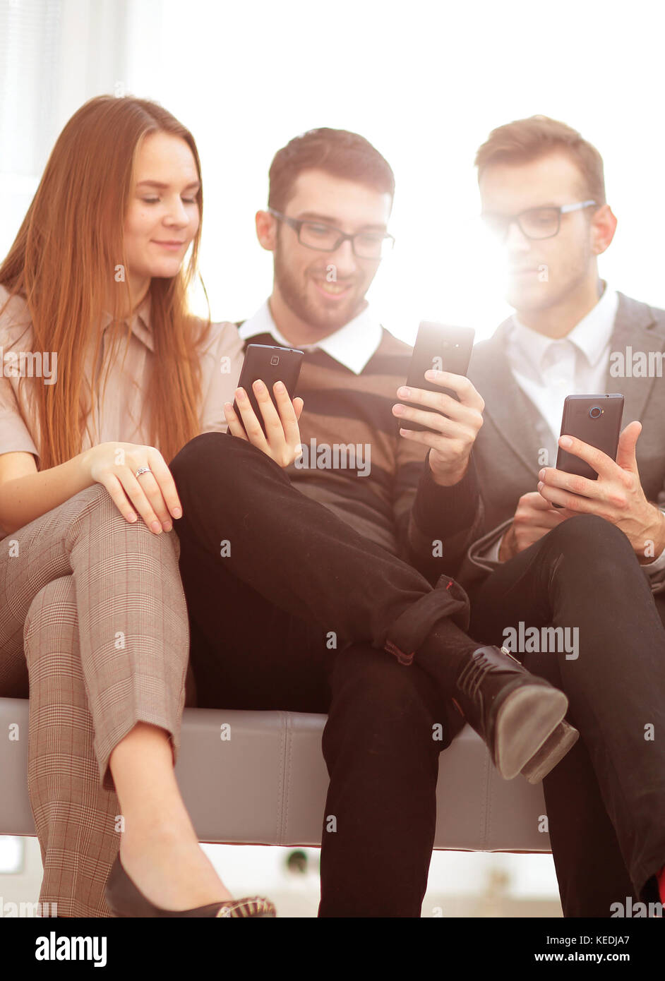 Group of young people use their phones Stock Photo - Alamy
