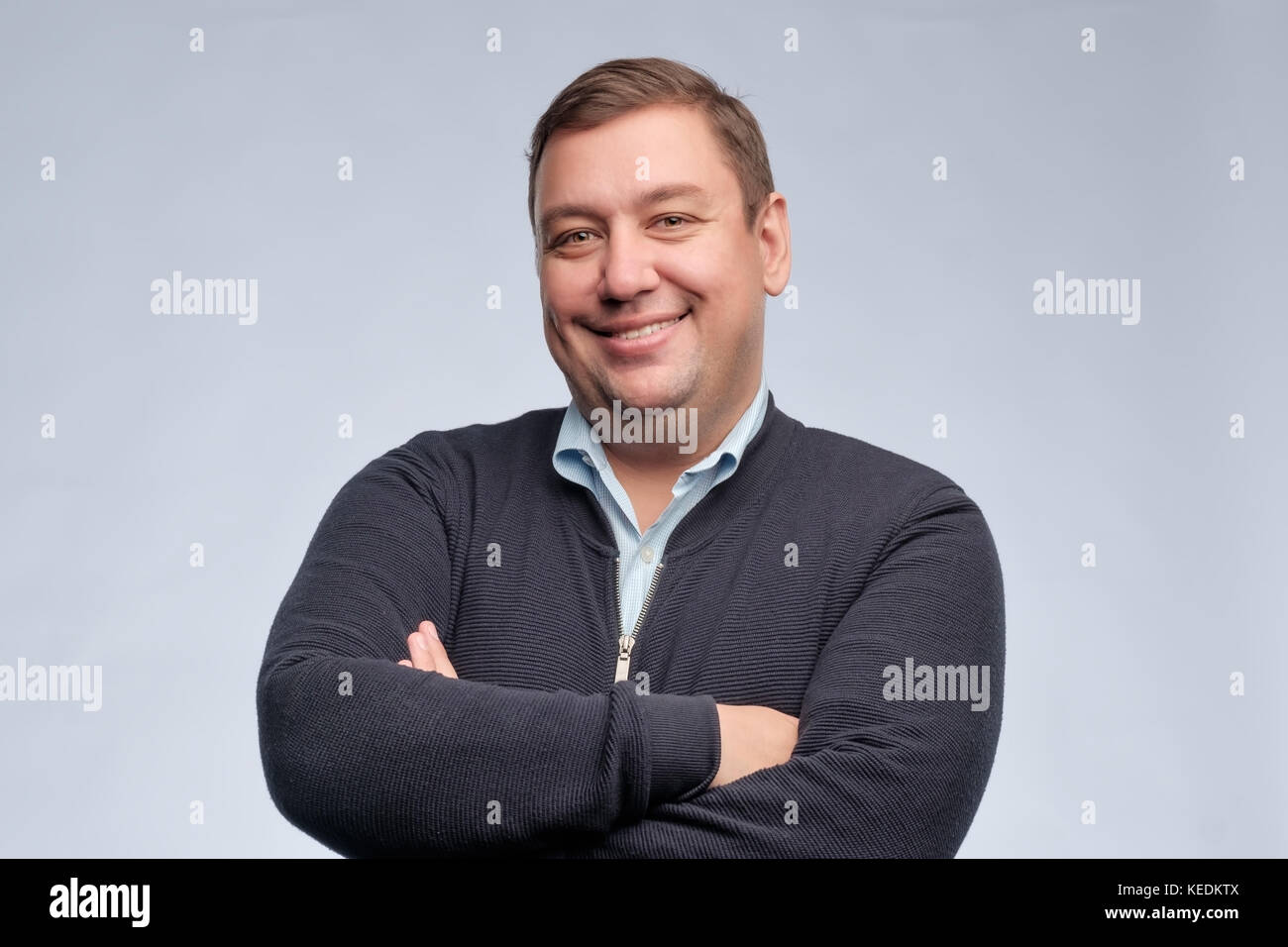 Half body portrait of confident middle aged man with folded arms ...
