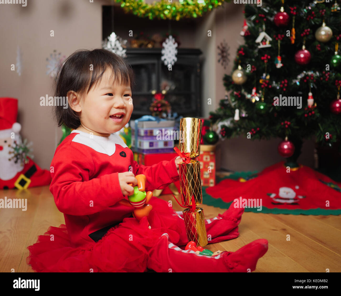 Happy santa baby girl play crackers Stock Photo - Alamy