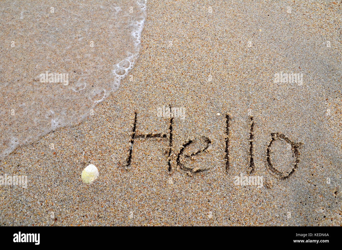 Hello word written on the sandy beach Stock Photo - Alamy