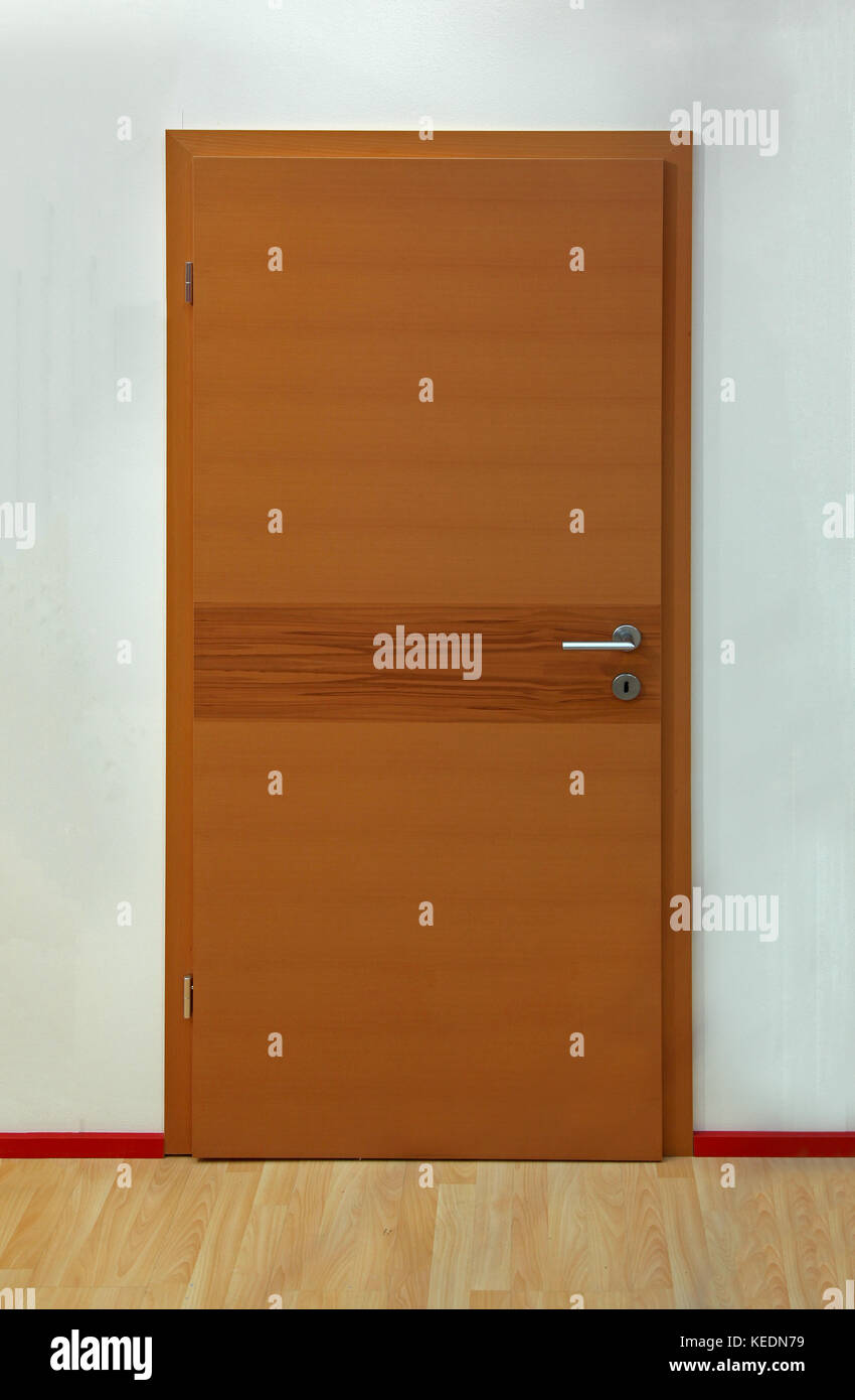 Closed interior brown door with silver handle Stock Photo - Alamy