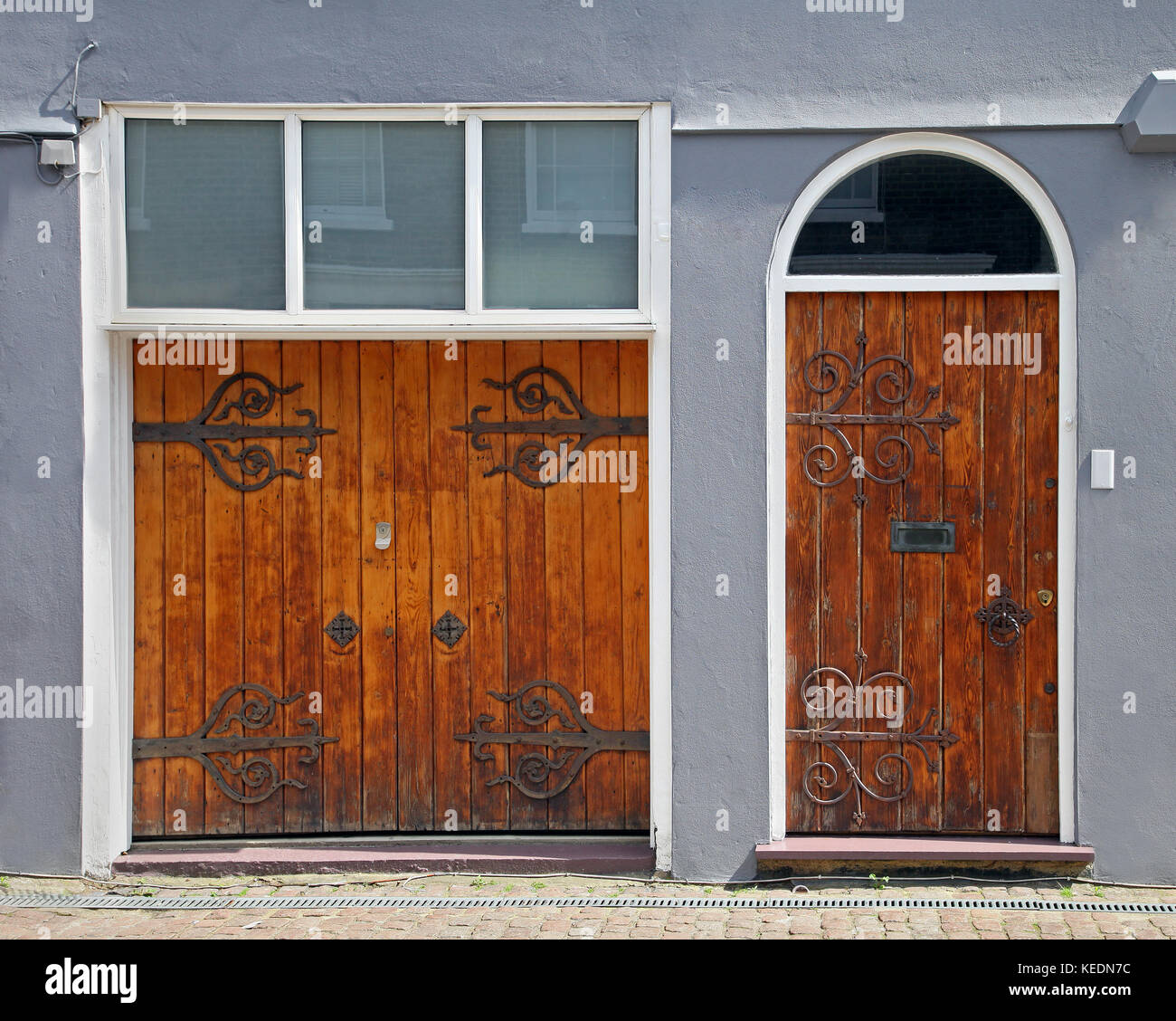 Residential house exterior with front entrance and garage doors Stock ...