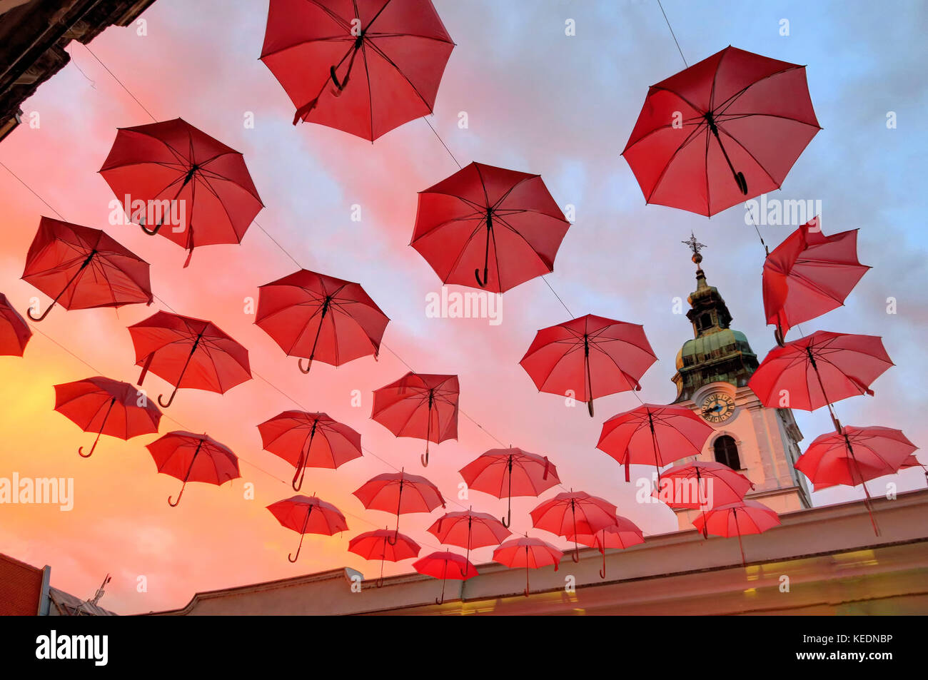 colorful urban art, umbrellas whimsically suspended in front of a ...