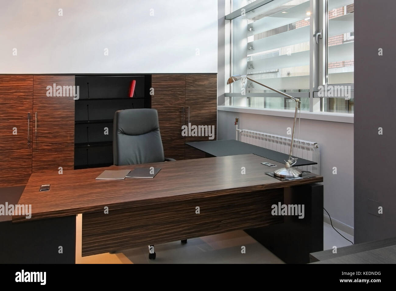 Wooden desk inside modern office interior with leather chair Stock ...