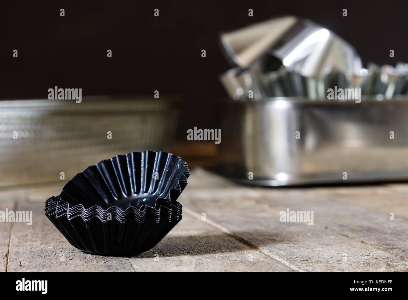 Old baking molds on an old kitchen table. Baking accessories in the ...