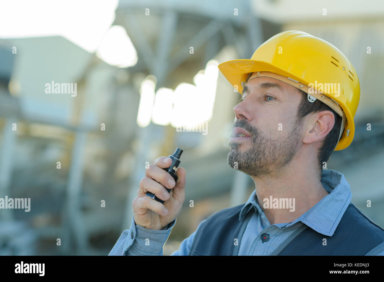 builder smoking cigarette on construction site Stock Photo - Alamy