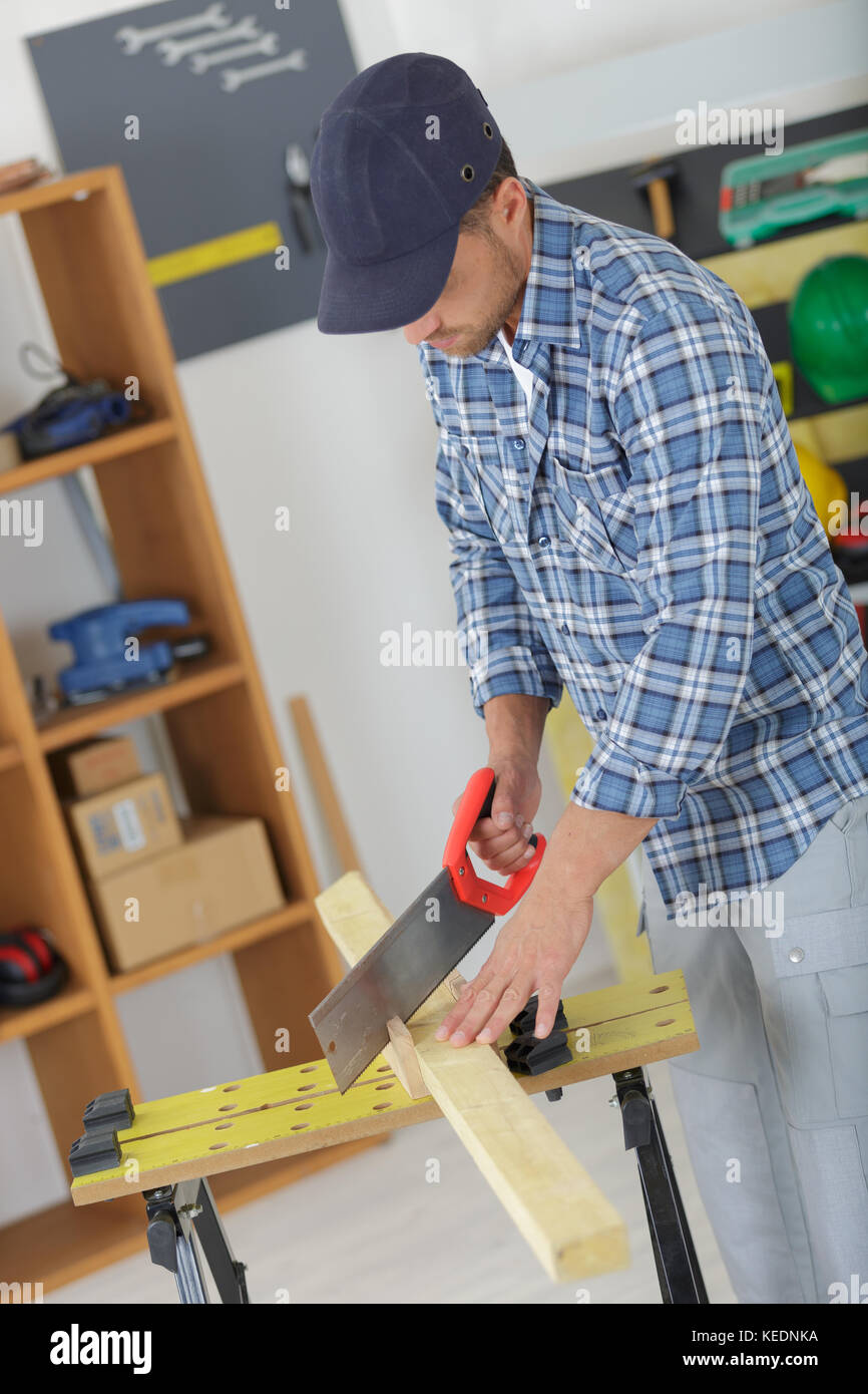 artisan carpenter cutting the wood using manual saw Stock Photo - Alamy