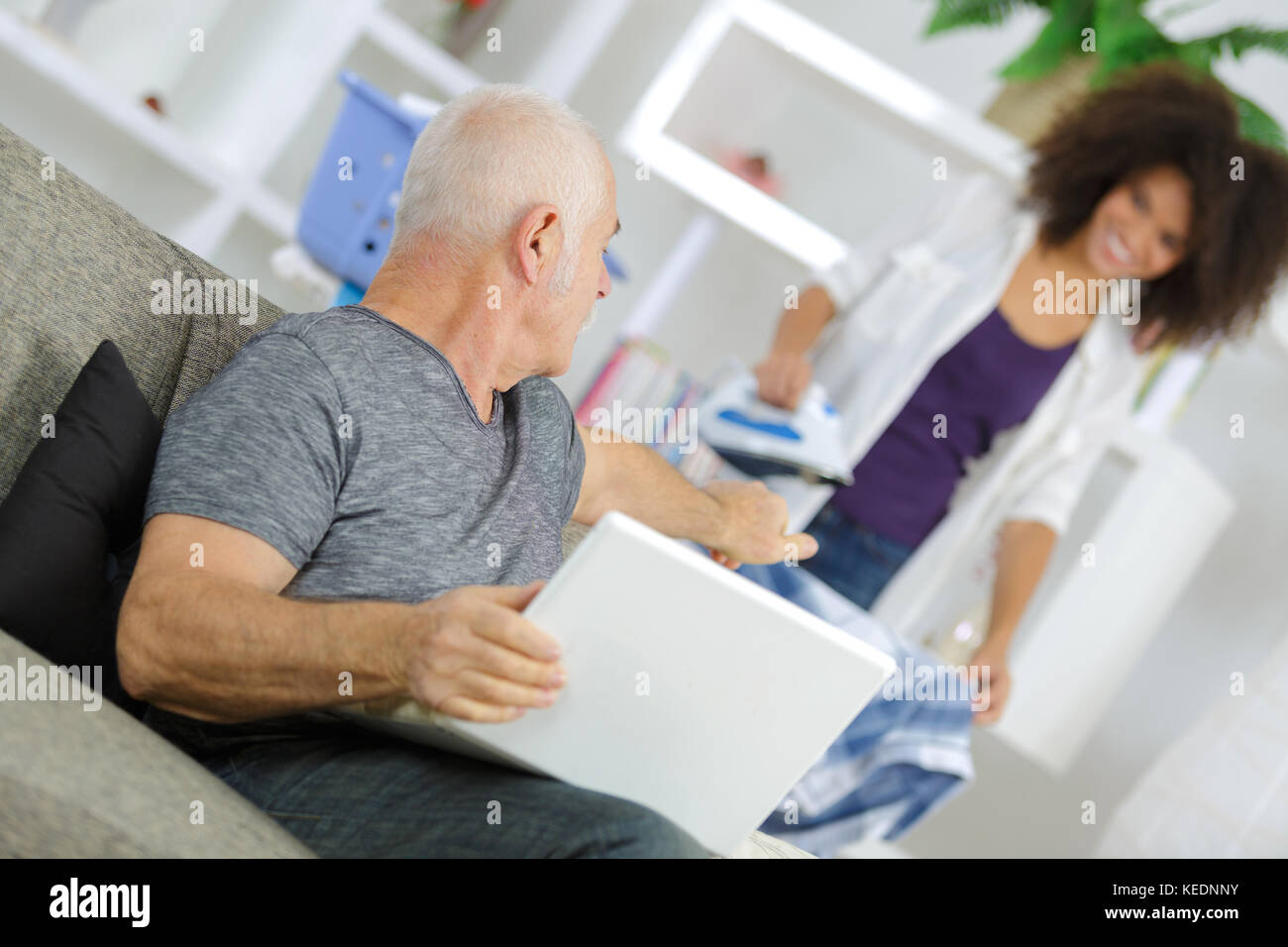 old man using laptop while talking to her assistant Stock Photo - Alamy