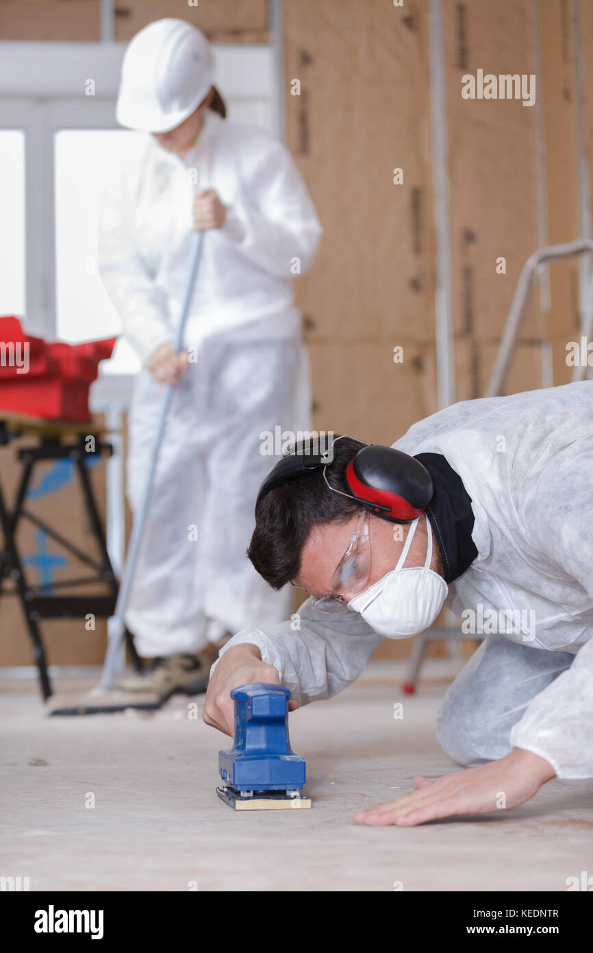 worker sanding floor at construction site Stock Photo - Alamy