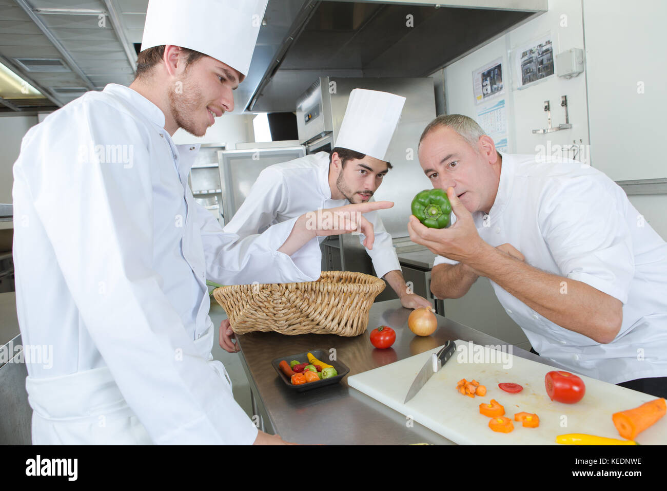 teacher helping students training to work in catering Stock Photo - Alamy