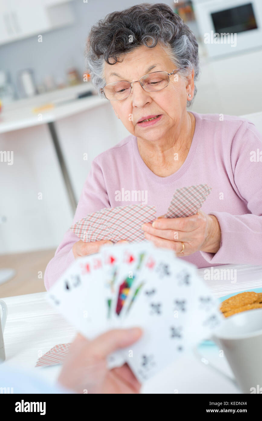 old lady playing a card game Stock Photo - Alamy
