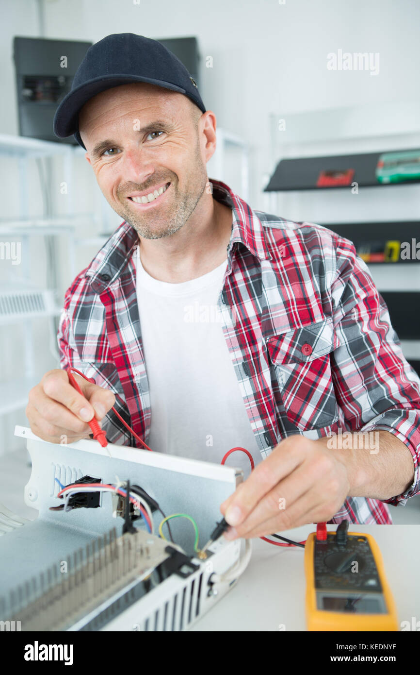 portrait of worker using multimeter Stock Photo - Alamy