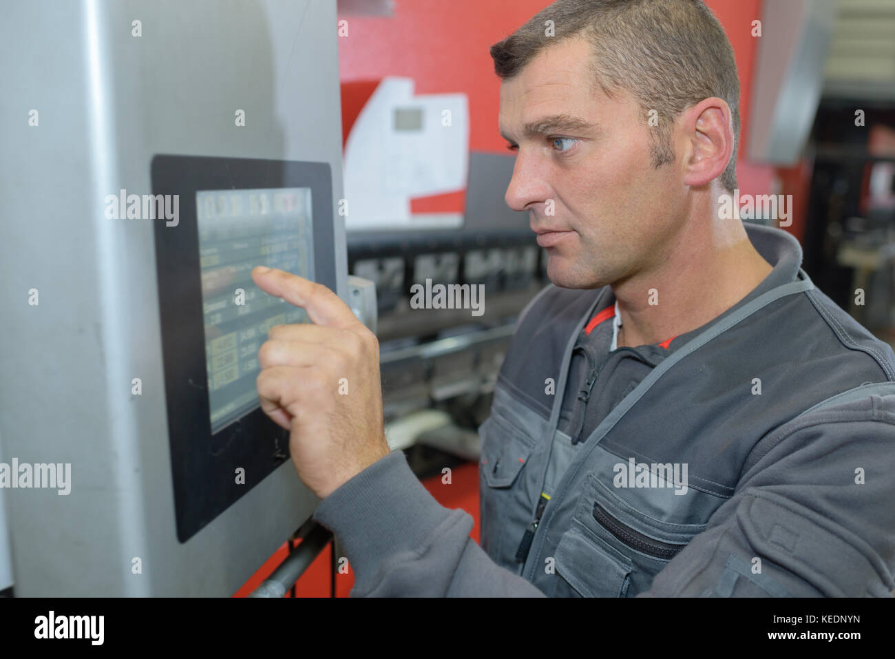 Man using touchscreen technology in factory Stock Photo - Alamy
