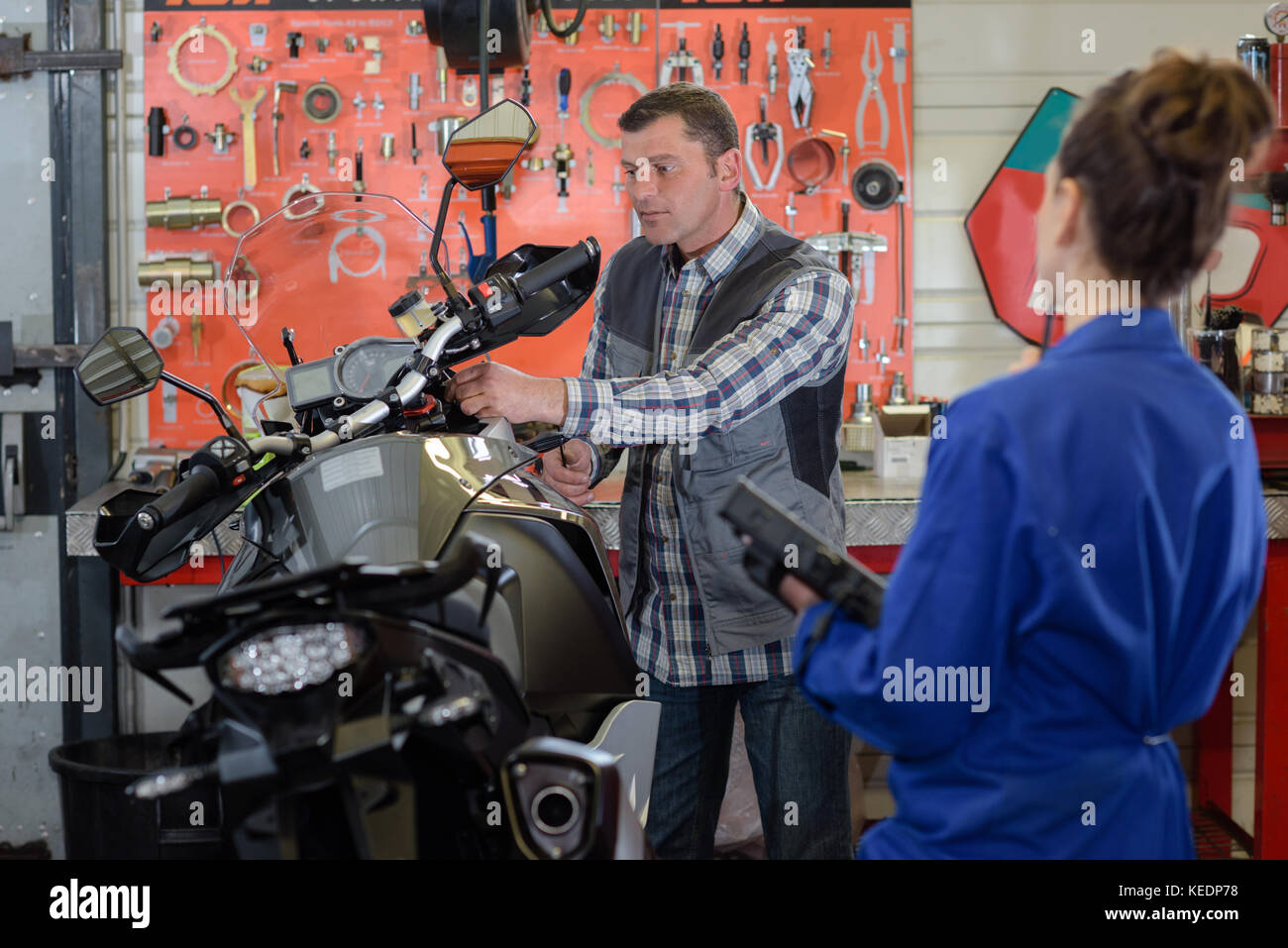 motorcycle mechanic and customer Stock Photo - Alamy