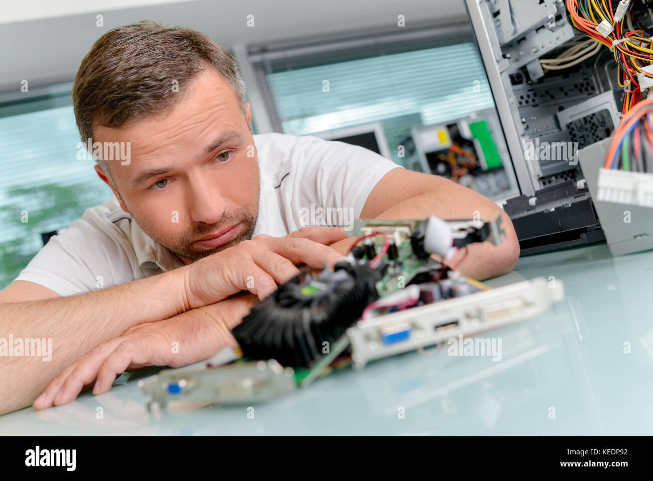 Sleepy computer technician Stock Photo - Alamy