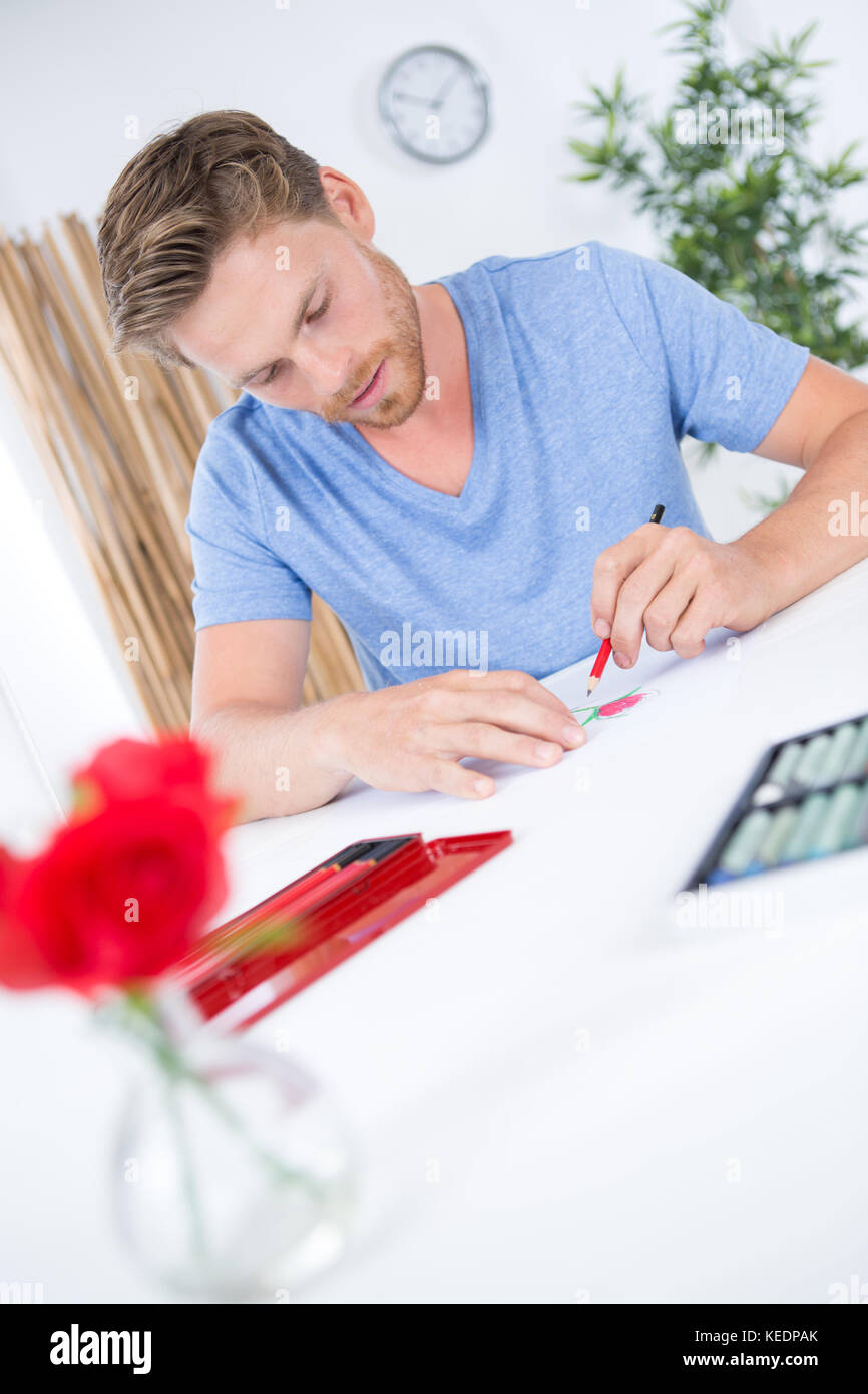 young man drawing pictures in studio Stock Photo - Alamy