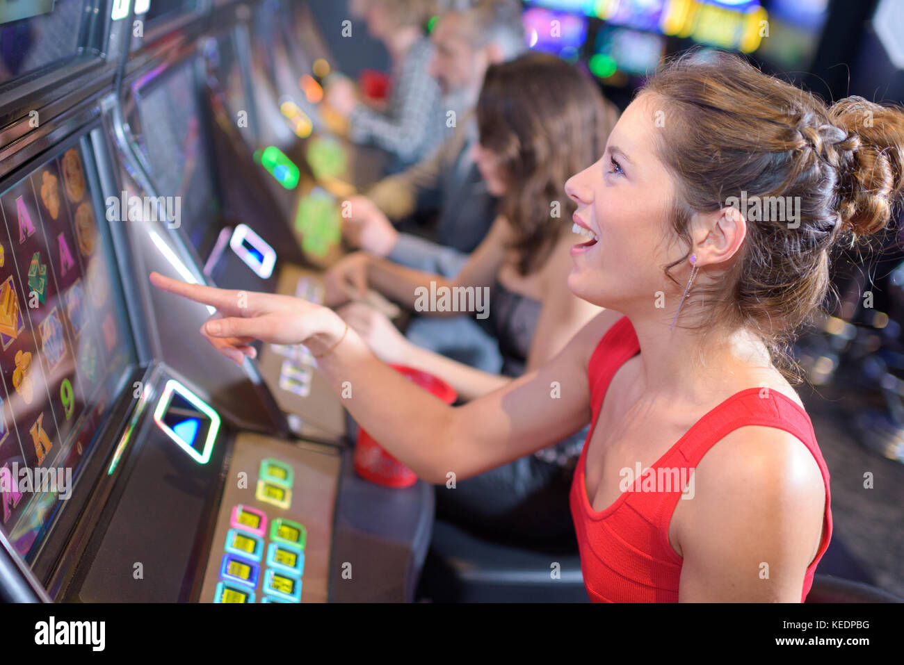 Woman playing arcade game Stock Photo - Alamy
