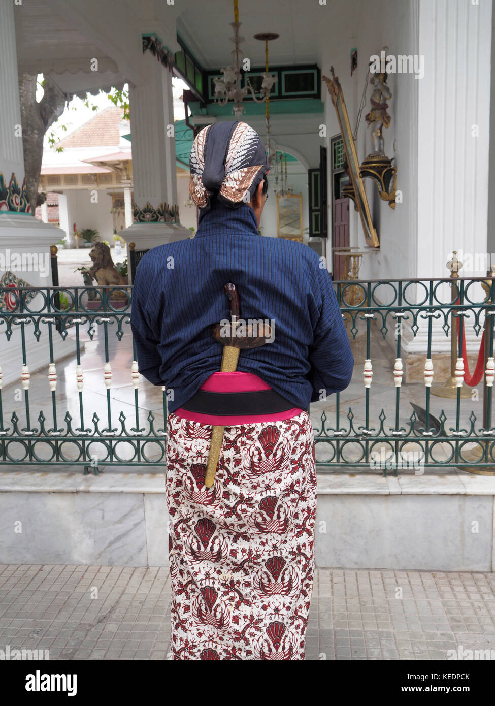 Royal guard with a kris on his back at the Kraton in Jogjakarta ...