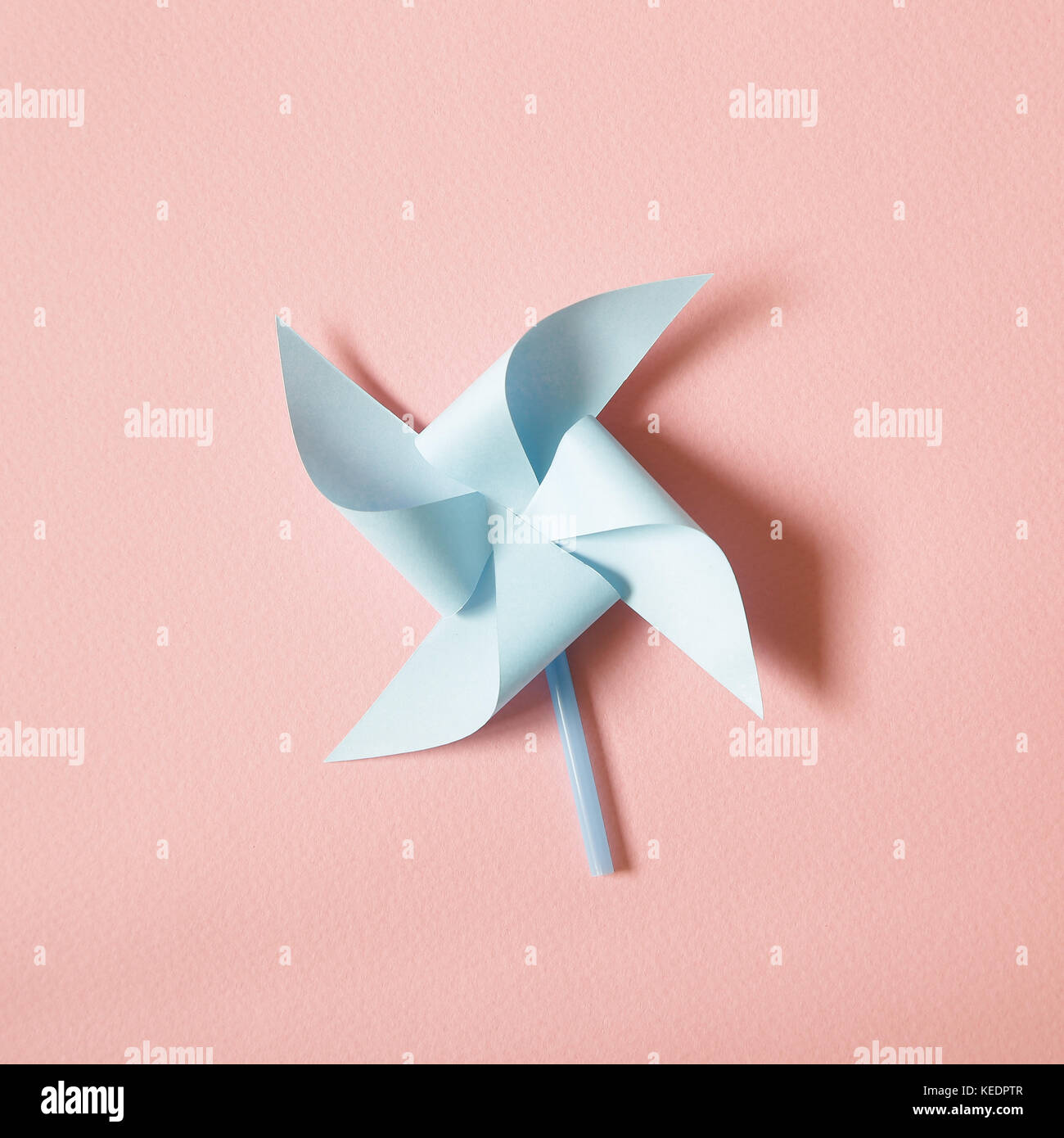 Blue paper pinwheel on pink background Stock Photo - Alamy