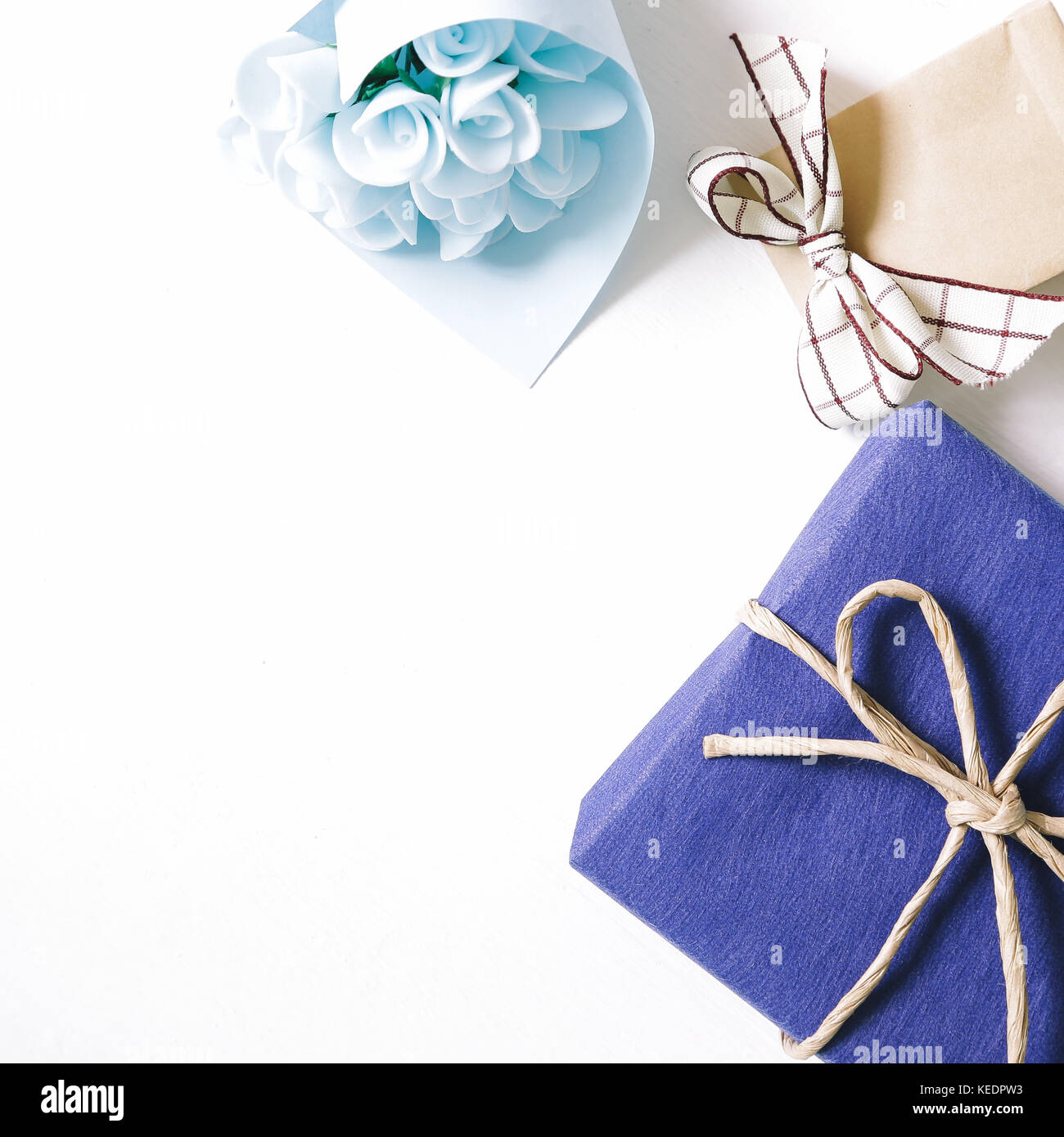 Blue gift and blue flower bouquet on white background Stock Photo - Alamy
