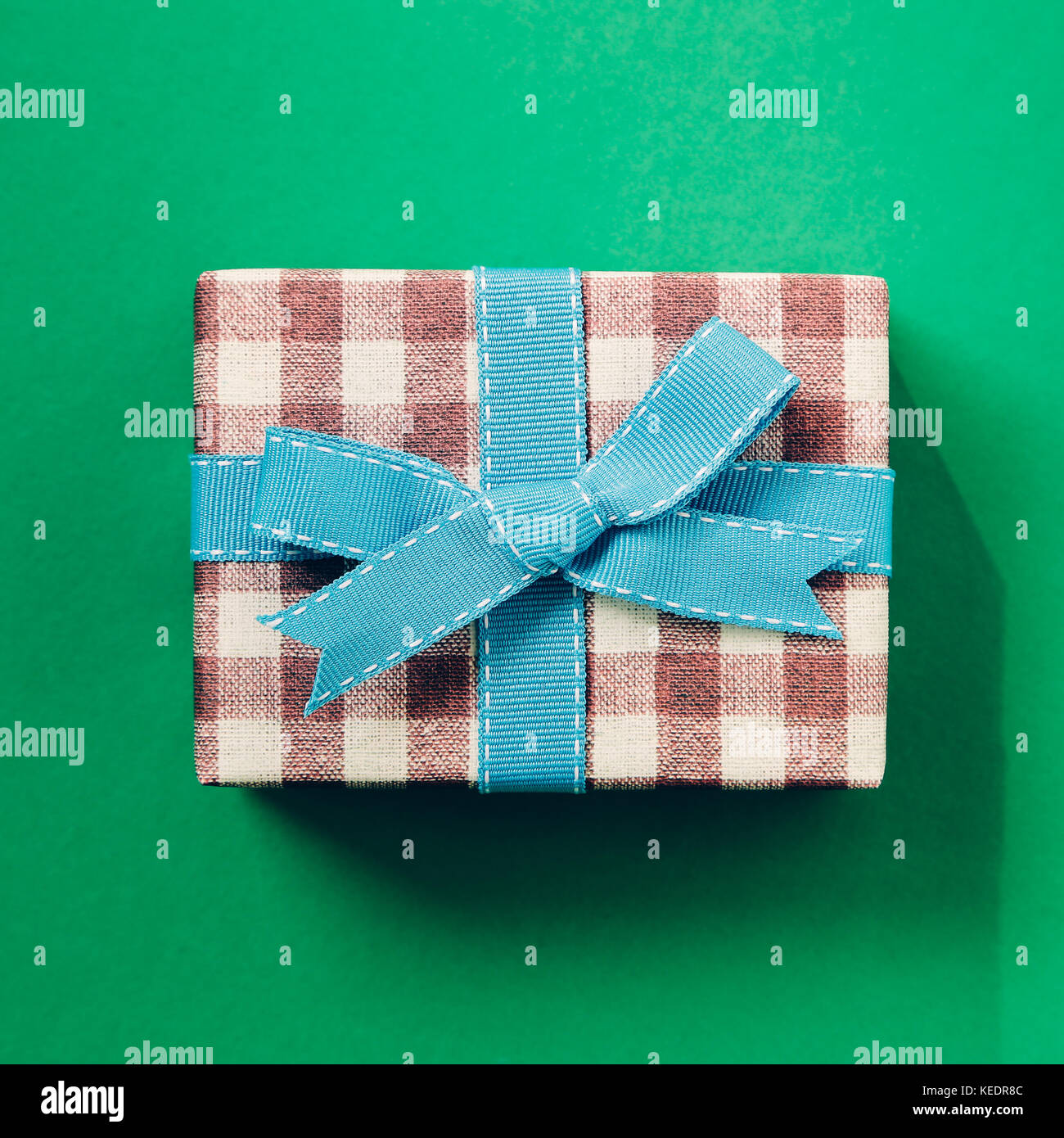 Gift on simple color paper background Stock Photo - Alamy