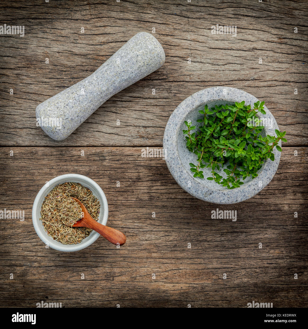 Closeup lemon thyme leaves from the herb garden in white mortar set up ...