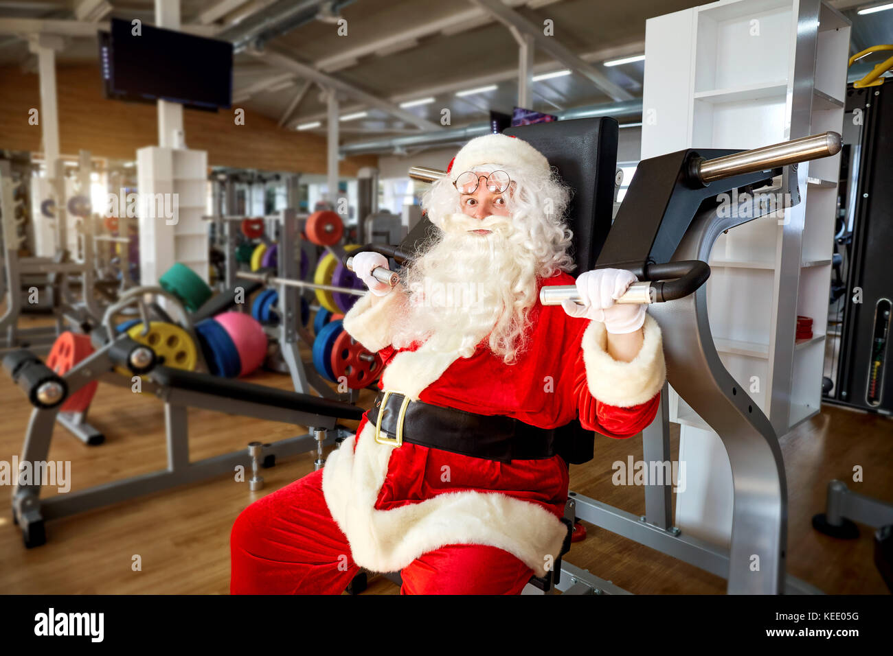 Santa Claus in the gym doing the exercises Stock Photo - Alamy