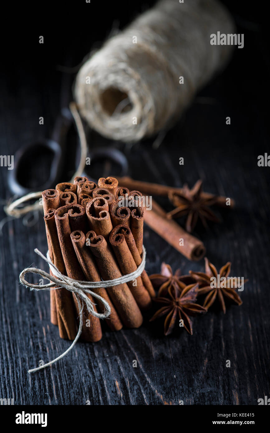 Cinnamon sticks bunch tied with rope on a dark background Stock Photo ...