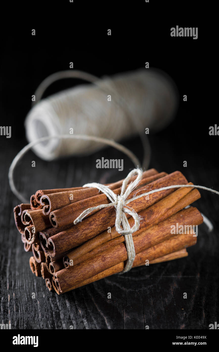 Cinnamon sticks bunch on a dark background Stock Photo - Alamy
