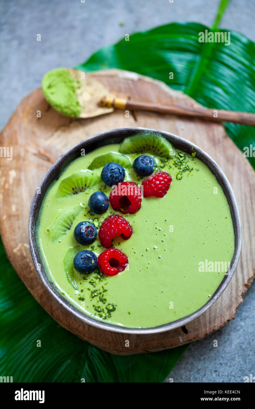 Green matcha smoothie with blueberries, raspberries and kiwi Stock ...