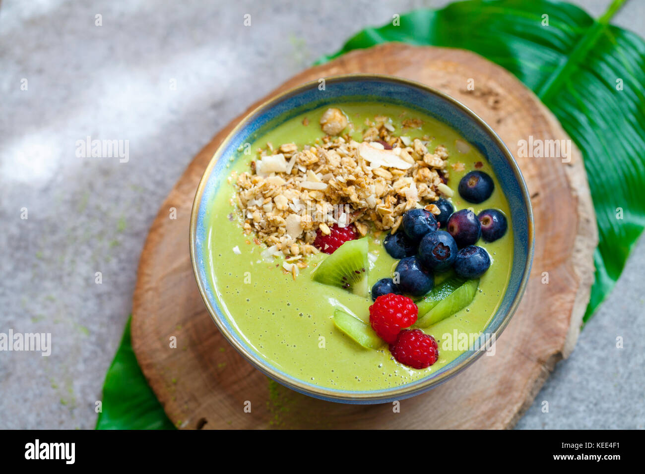 Green matcha smoothie with blueberries, raspberries and kiwi Stock ...