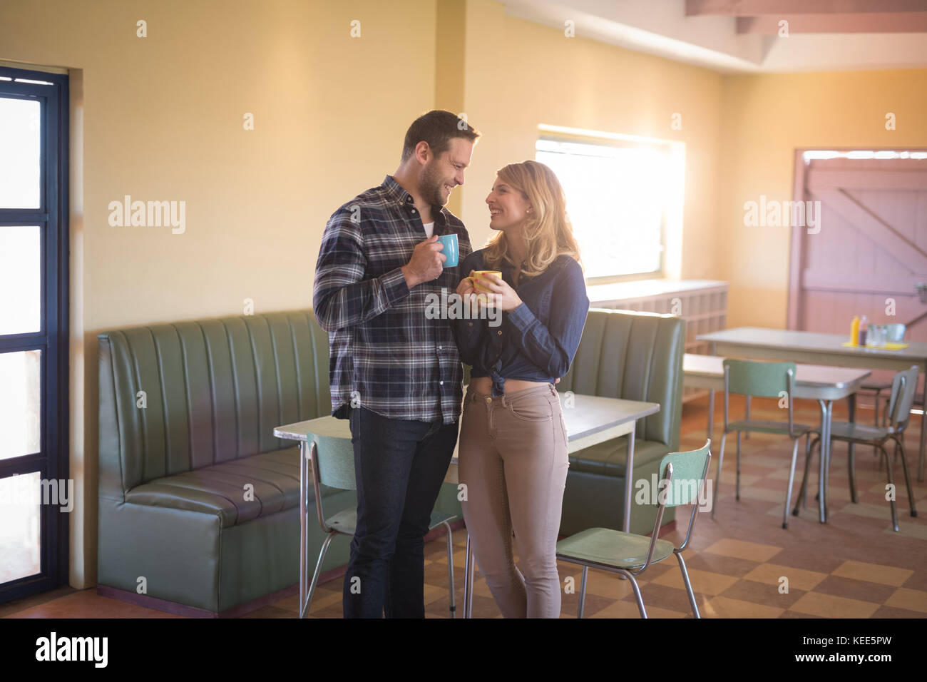 Happy couple having coffee in restaurant Stock Photo - Alamy