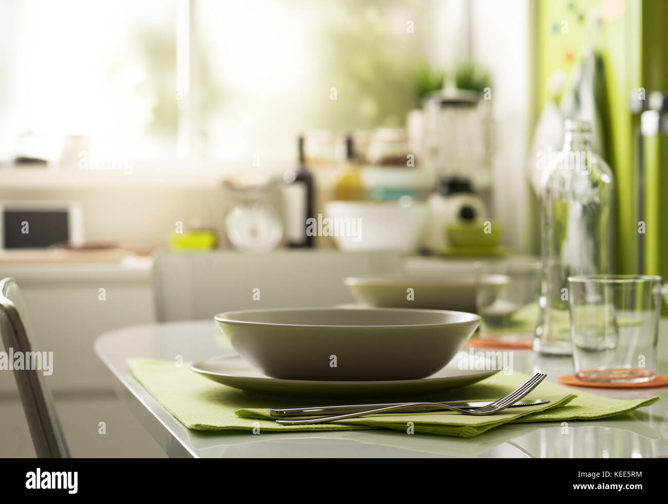 Modern kitchen interior, table setting, dishware and flatware on the ...