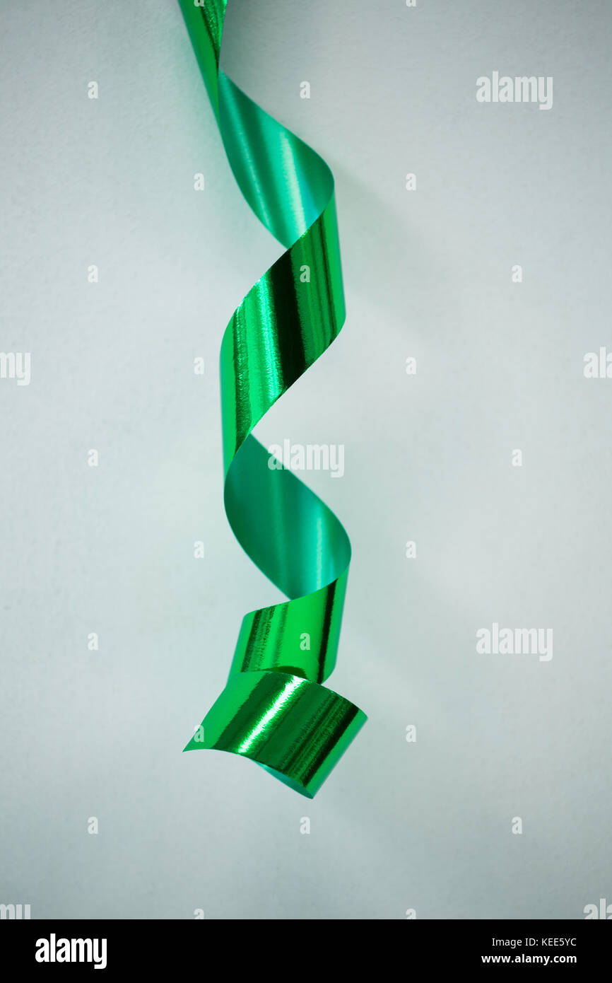 Close-up of green streamers on white background Stock Photo - Alamy
