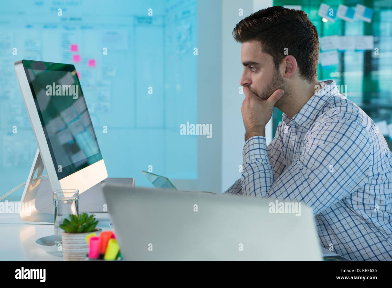 Male executive working on personal computer at desk in office Stock ...