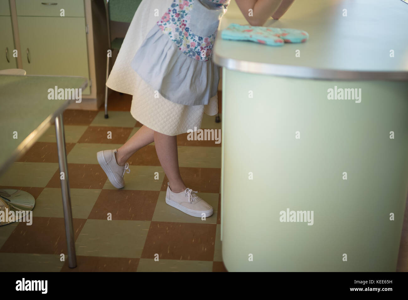 Low-section of waitress leaning at counter in restaurant Stock Photo ...