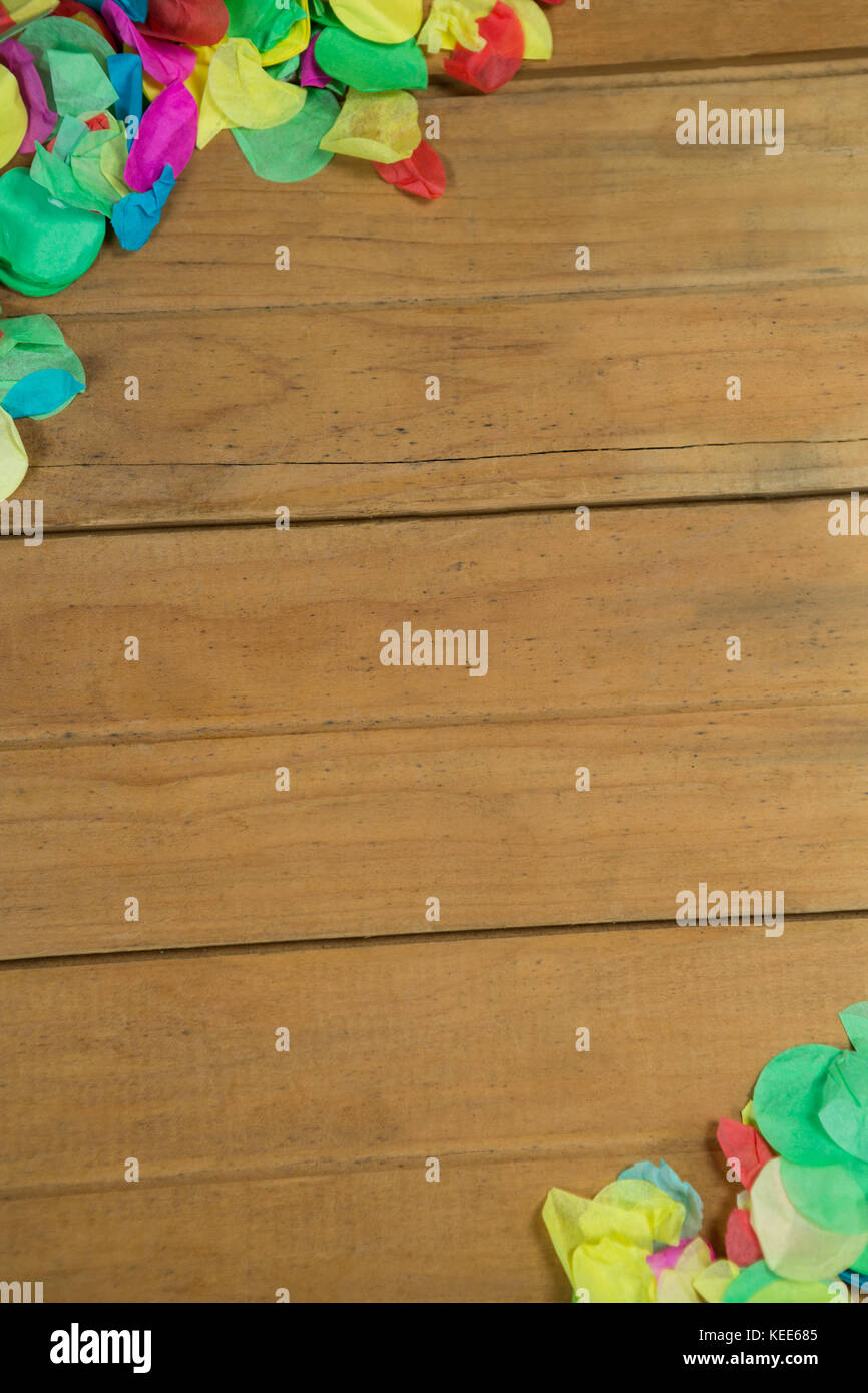 Overhead of confetti on wooden surface Stock Photo - Alamy