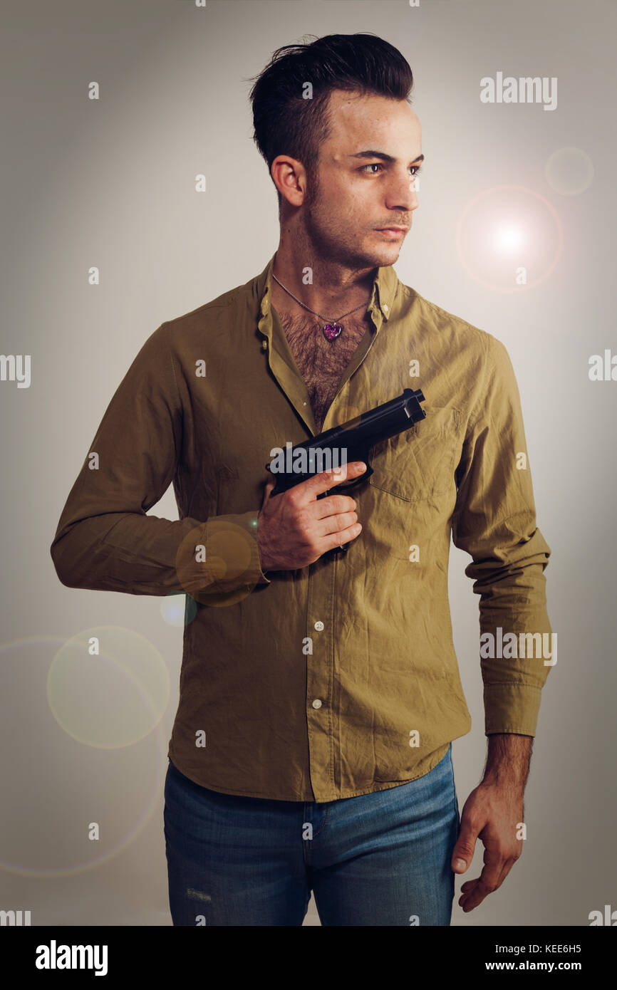 Boy with gun on white background Stock Photo - Alamy