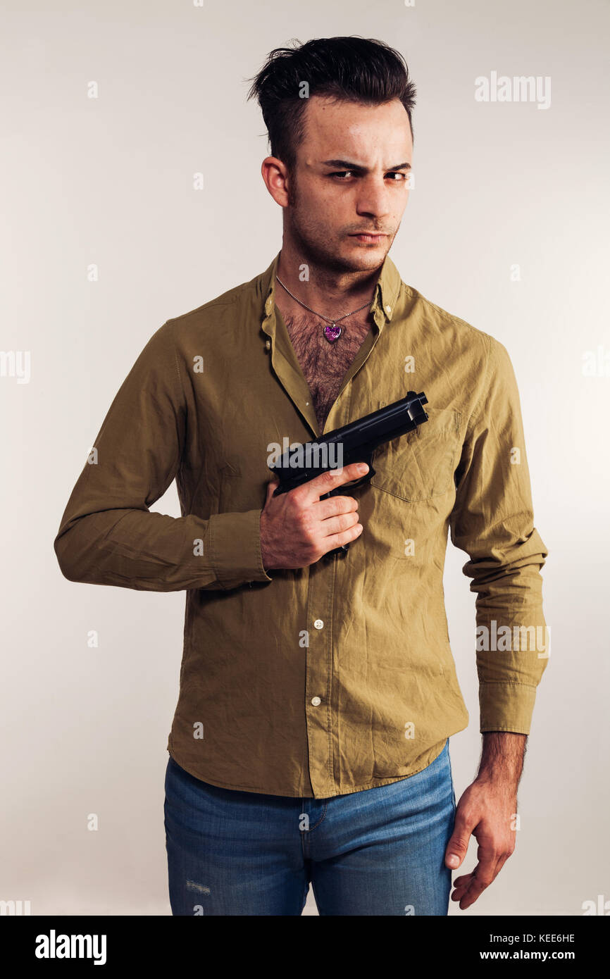 Boy with gun on white background Stock Photo - Alamy