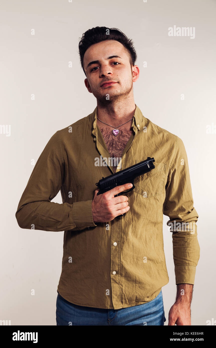 Boy with gun on white background Stock Photo - Alamy