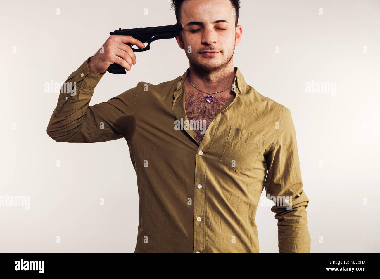 Boy with gun on white background Stock Photo - Alamy