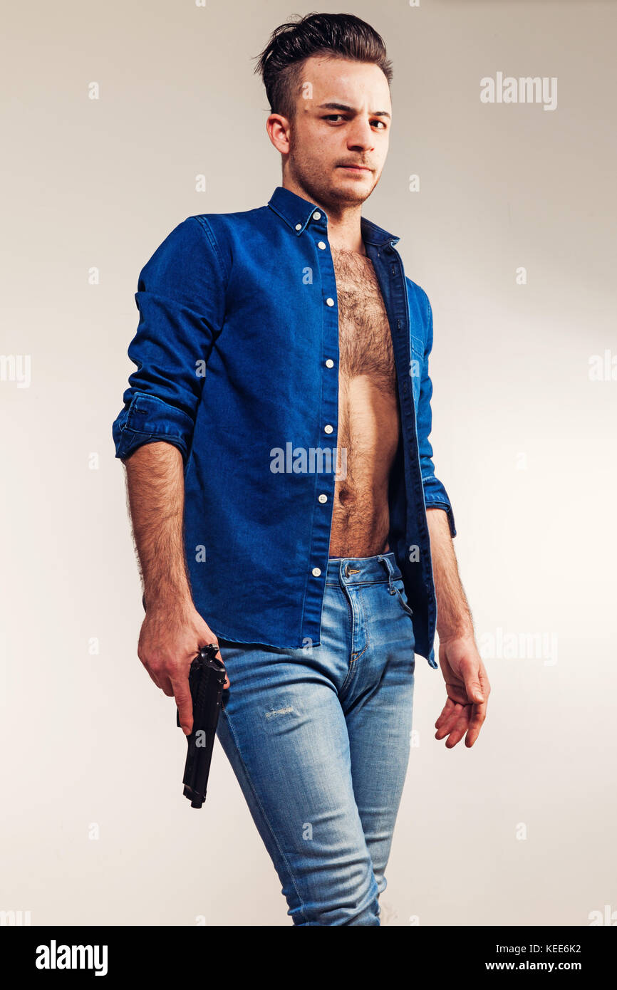 Boy with gun on white background Stock Photo - Alamy