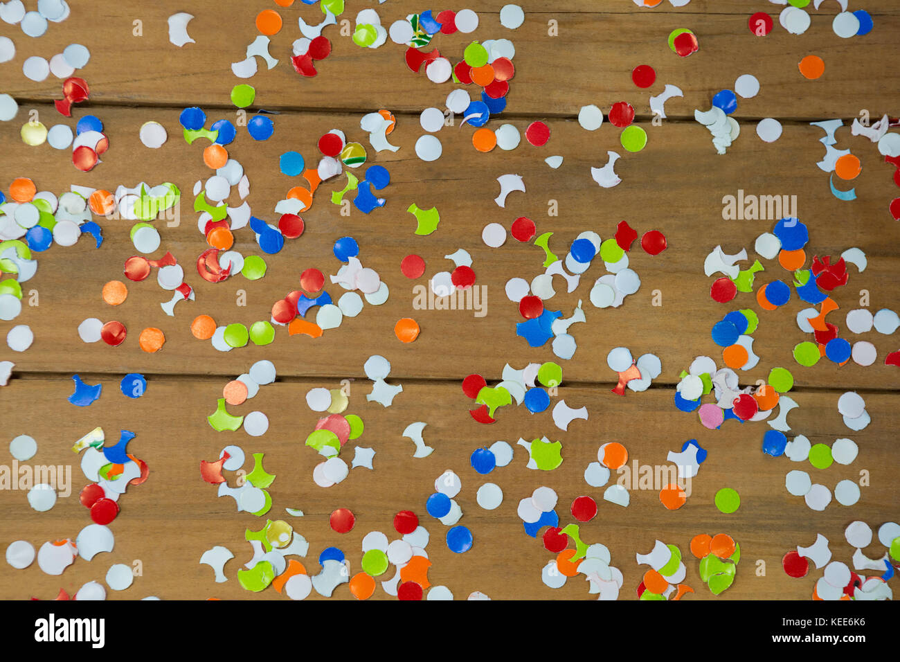 Overhead of confetti on wooden surface Stock Photo - Alamy