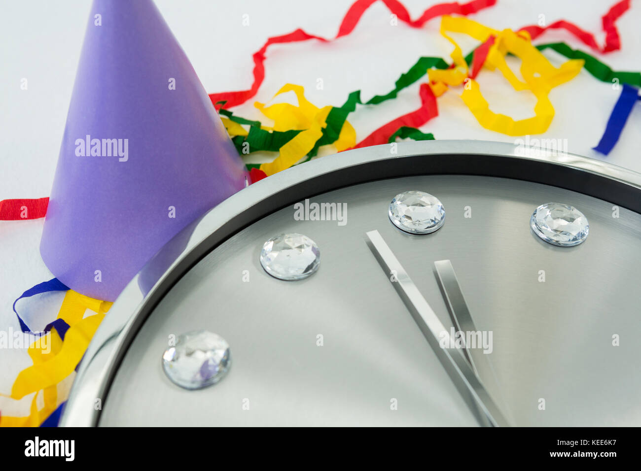 Close-up of clock and streamers against white background Stock Photo ...
