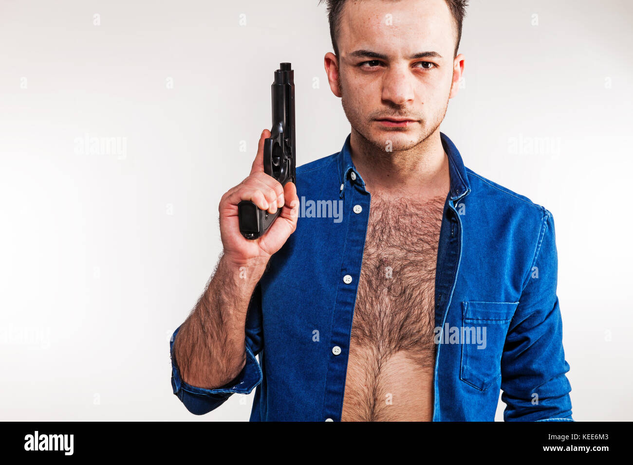 Boy with gun on white background Stock Photo - Alamy