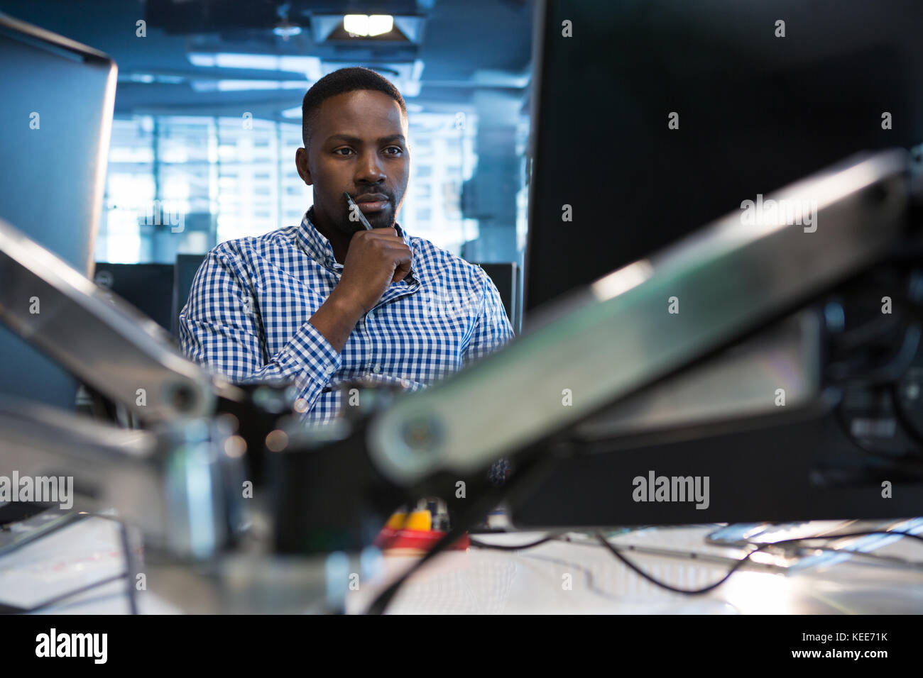 Computer engineer working at desk in office Stock Photo - Alamy